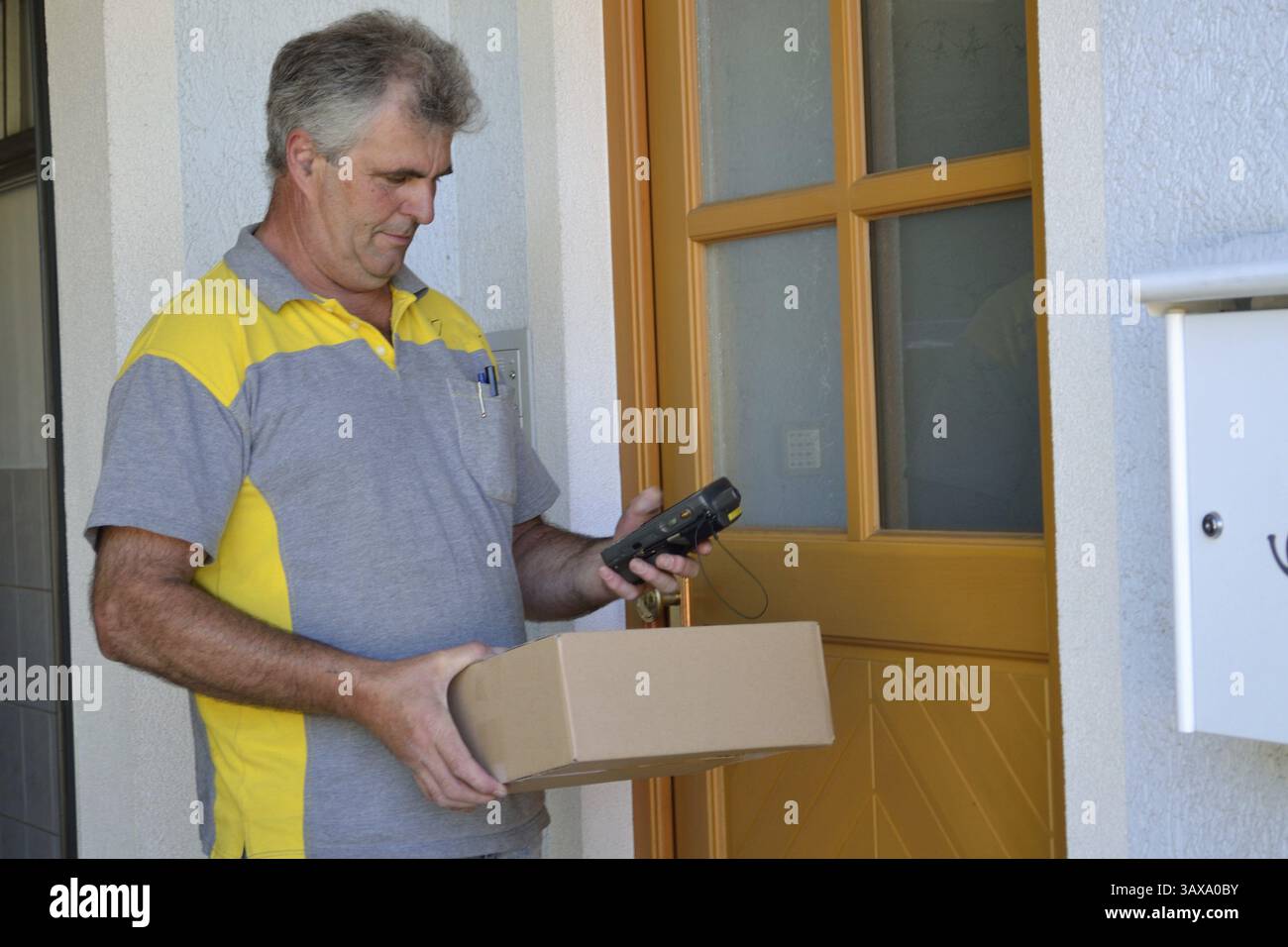 Postman delivers parcel house hi-res stock photography and images - Alamy