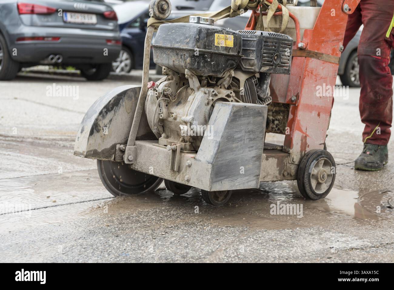 Construction worker cuts asphalt with joint cutter - Construction ...
