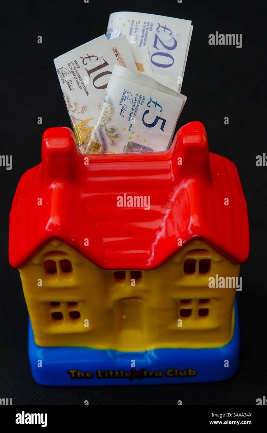 File photo dated 23/06/23 of UK £5, £10 and £20 notes in a money box ...