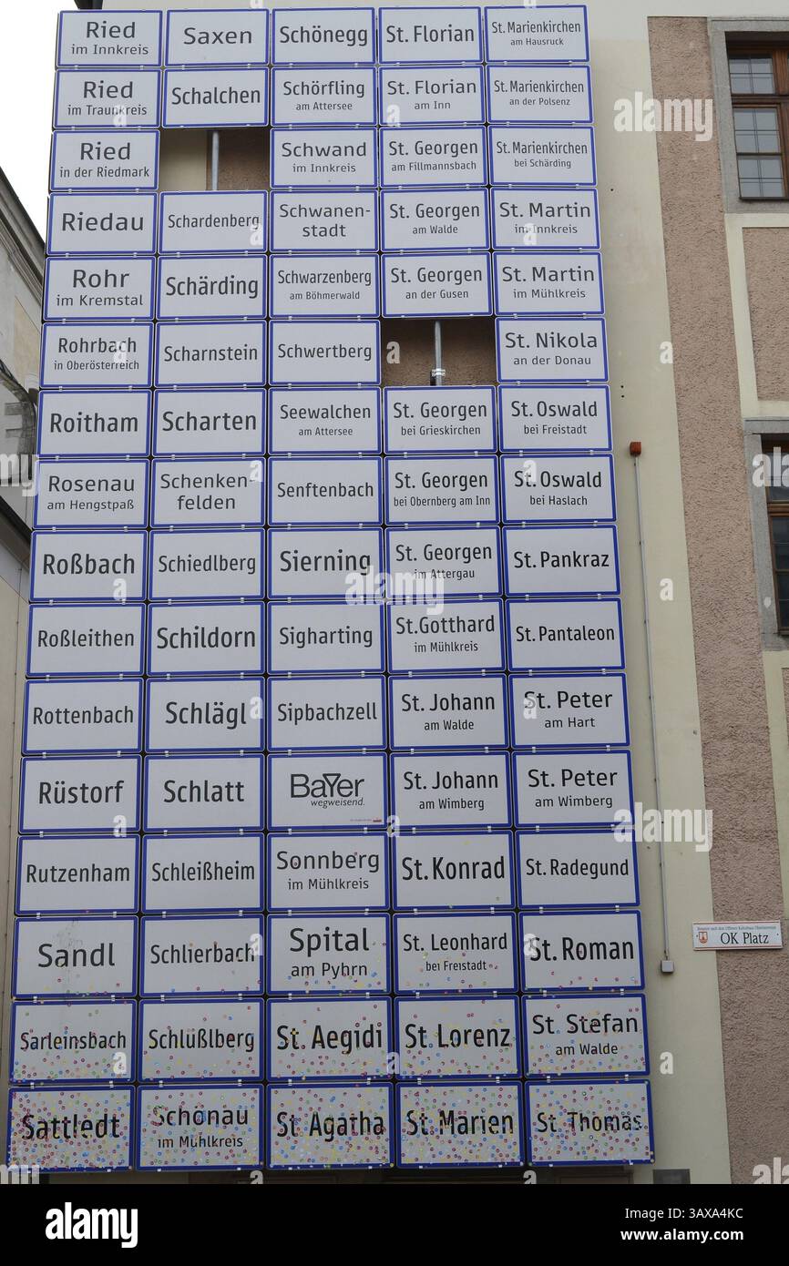 Collection of place name signs on the square in Linz Stock Photo - Alamy