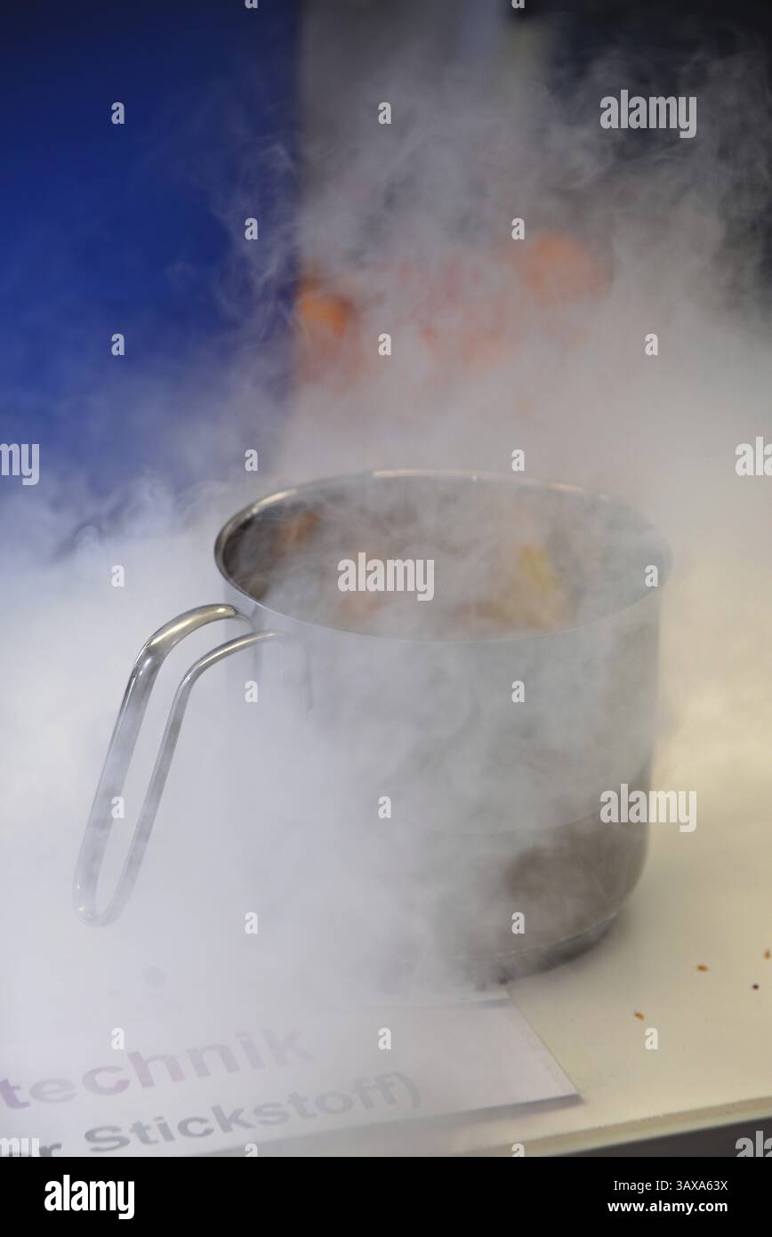 Liquid nitrogen steams out of milk pot - chemical experiment Stock ...