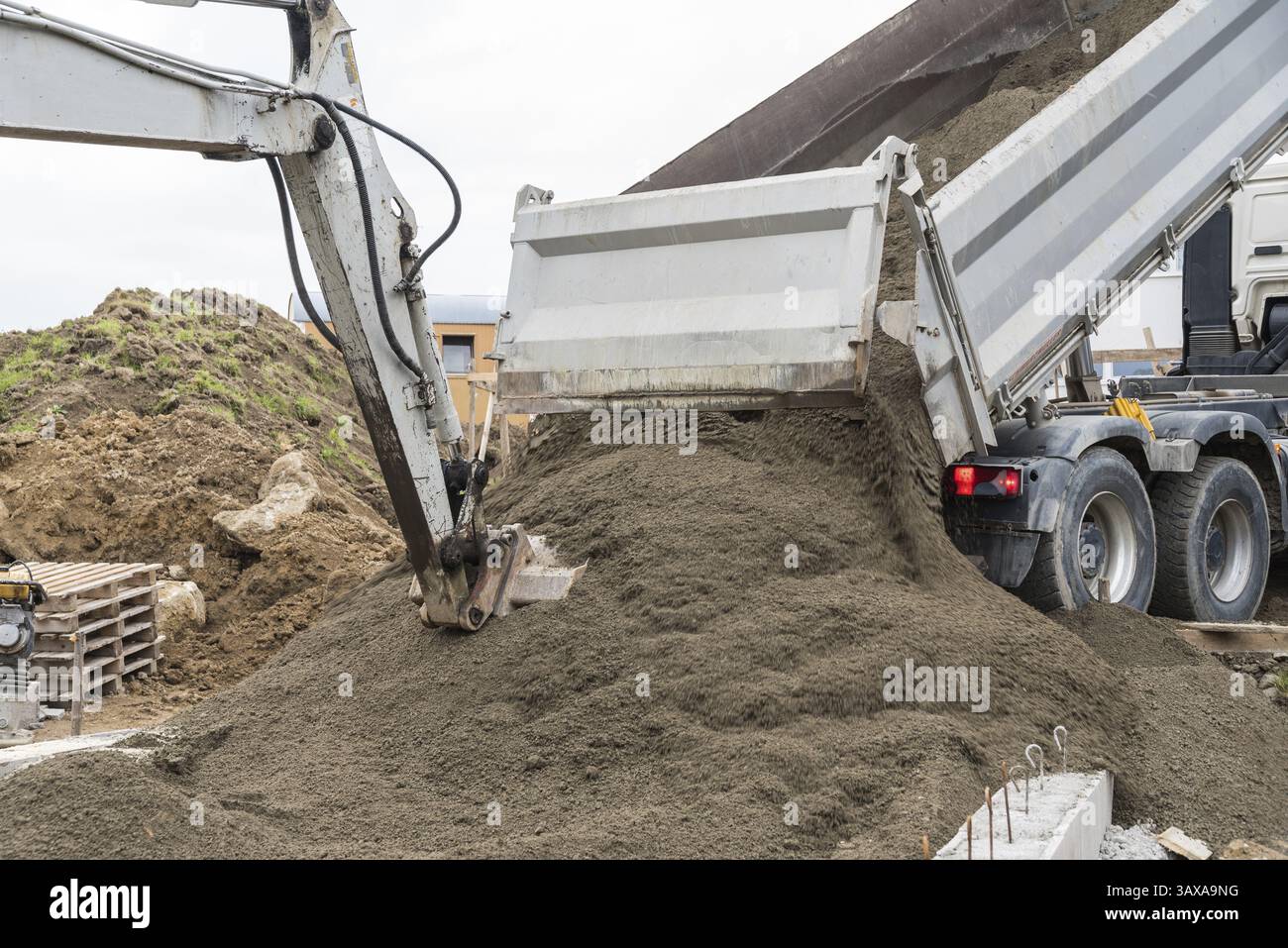 Excavators and lorries unloading the delivery - construction site ...