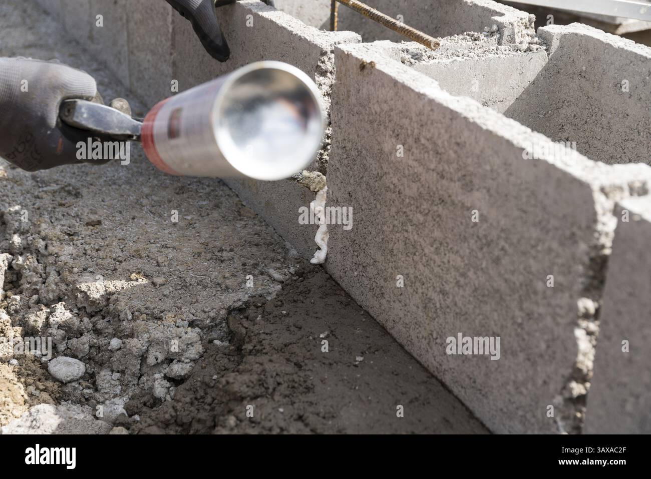 Construction worker working with assembly foam on a building site ...