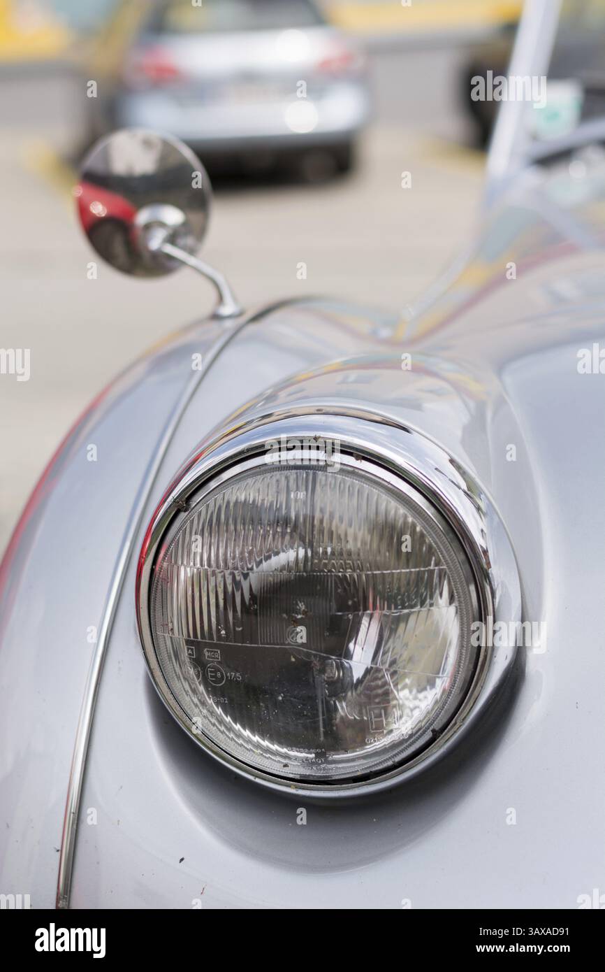 Classic car - Headlights and rear-view mirror of a classic car in view ...