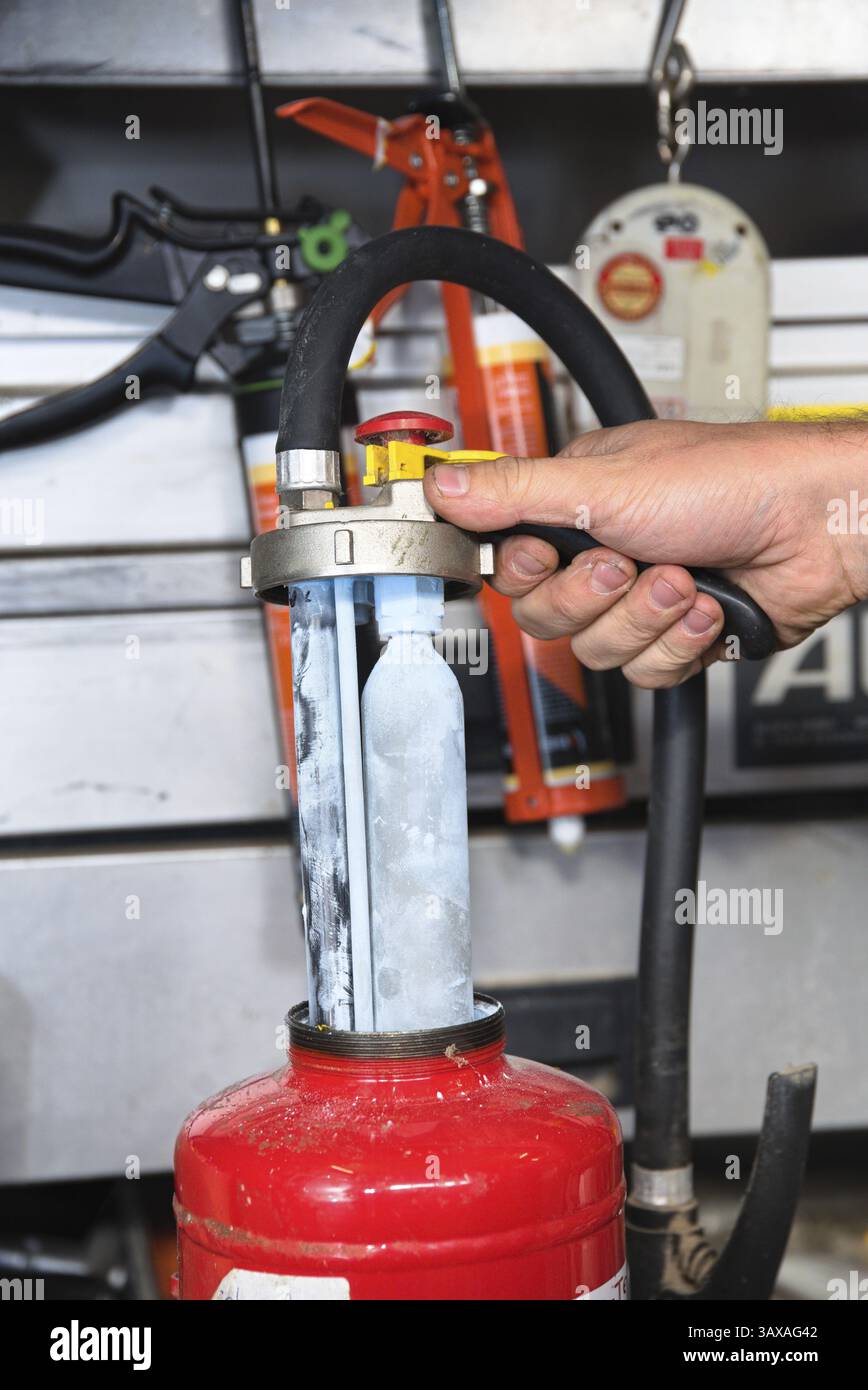Old fire extinguisher is checked by a specialist - safety for ...