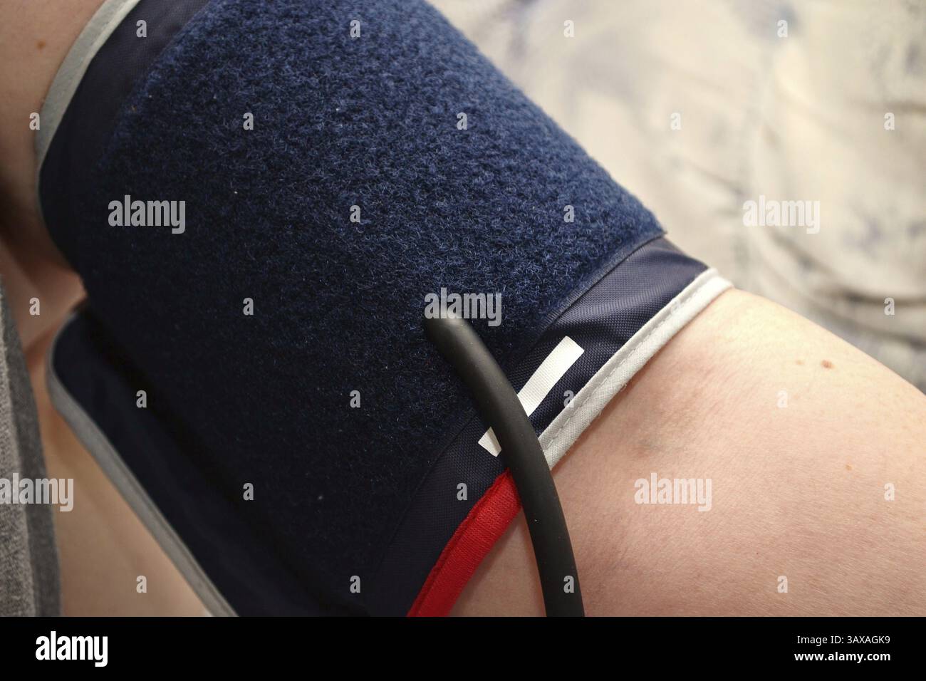 Blood pressure cuff on the upper arm Stock Photo - Alamy