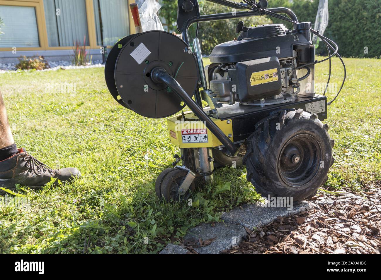 Laying cables as a boundary for robot lawn mowers Stock Photo - Alamy