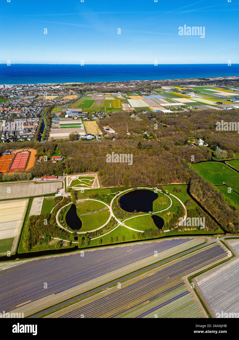 Aerial view of a uniquely designed park with circular paths and ponds ...