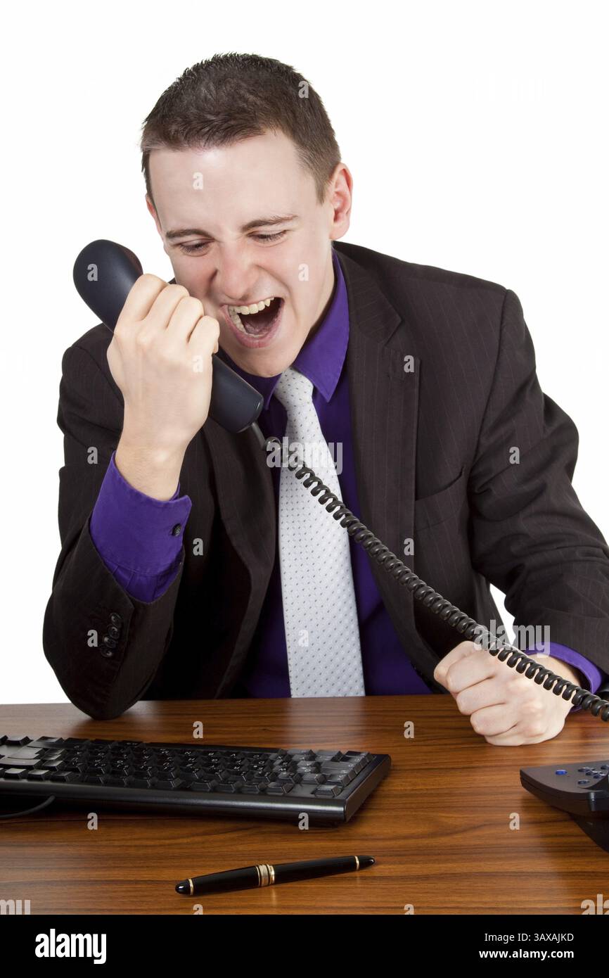 Young businessman screaming into telephone - isolated Young businessman ...