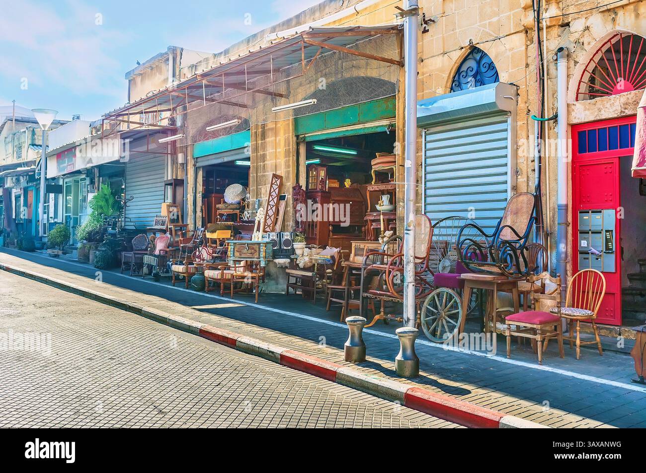 The city street with vintage furniture stalls at the large flea market ...