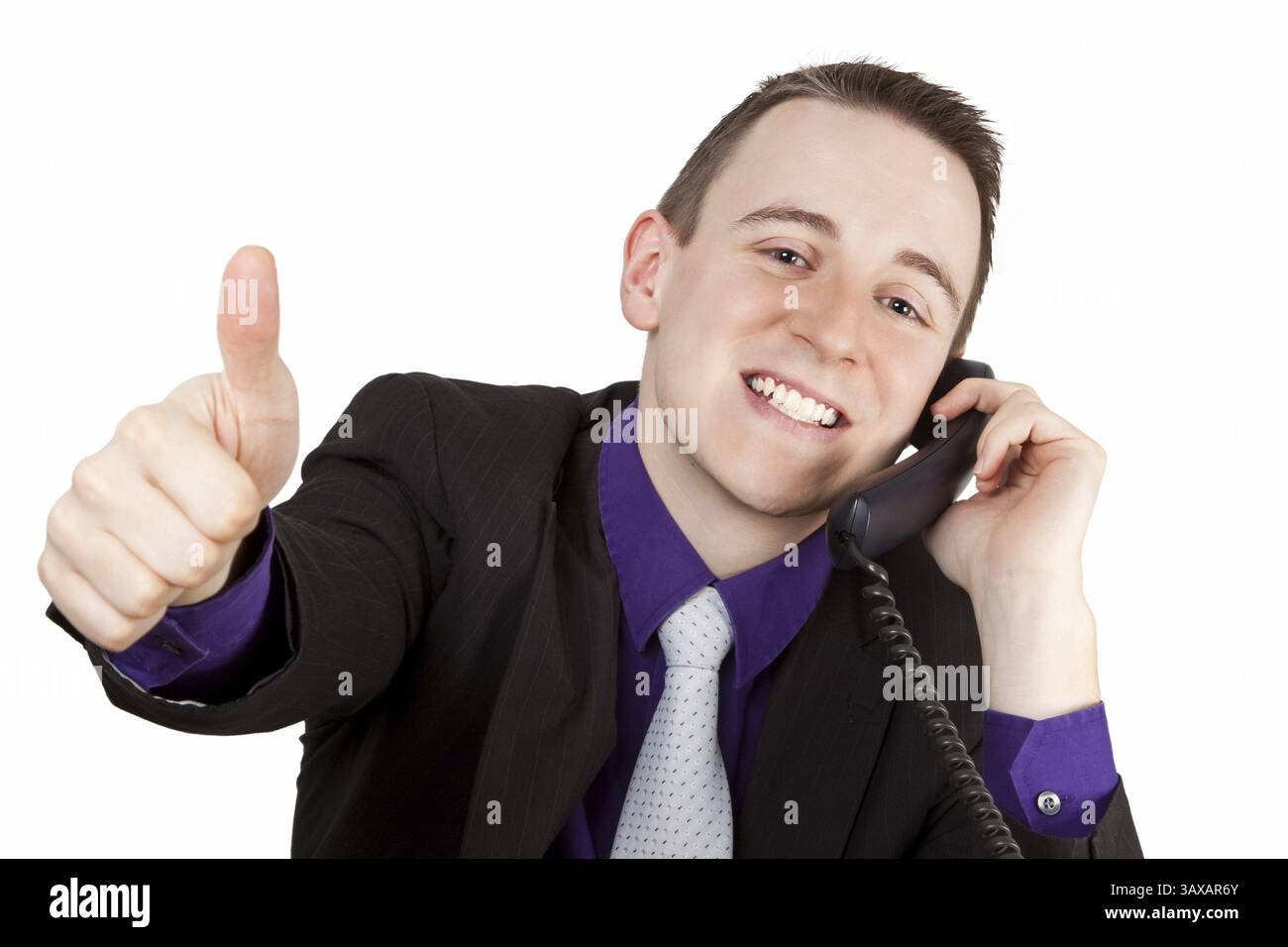 Young businessman on the phone holding thumbs up - isolated Young ...