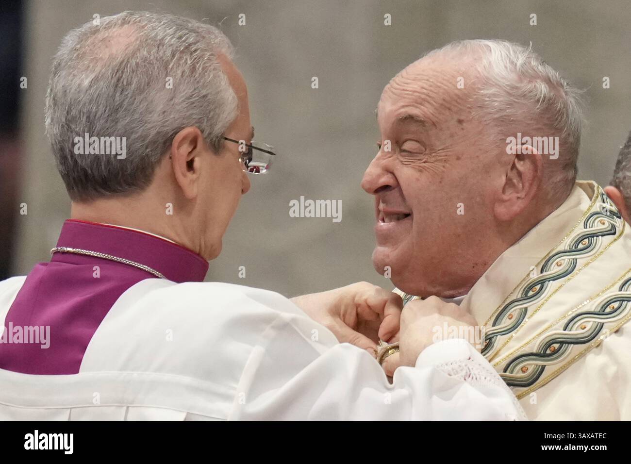 FILE - Pope Francis is helped by Vatican Master of Ceremonies, Bishop ...