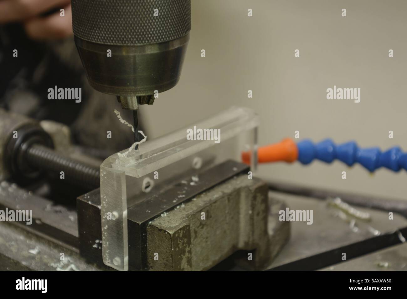Drilling a hole in plastic with a drill - close-up Stock Photo - Alamy