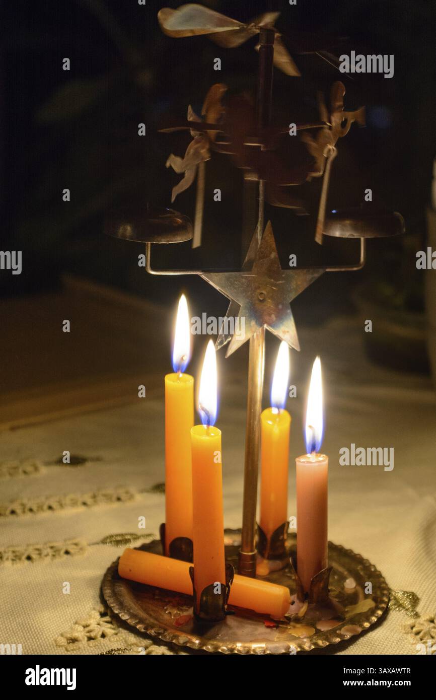 Burning Christmas tree candles operate an atmospheric bell ringing ...