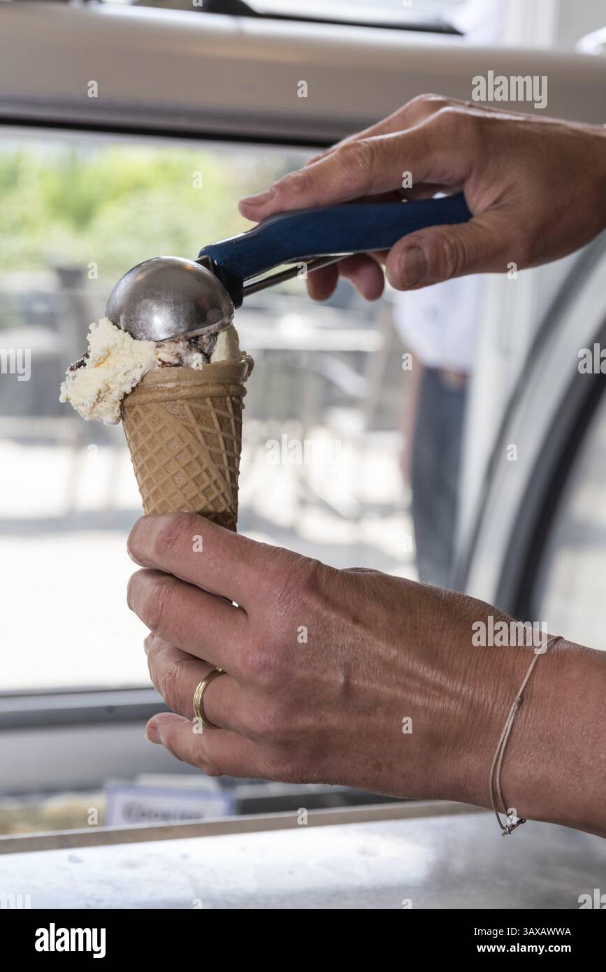Fresh ice cream scoop in a wafer cone as a dessert - Close-up of ice ...