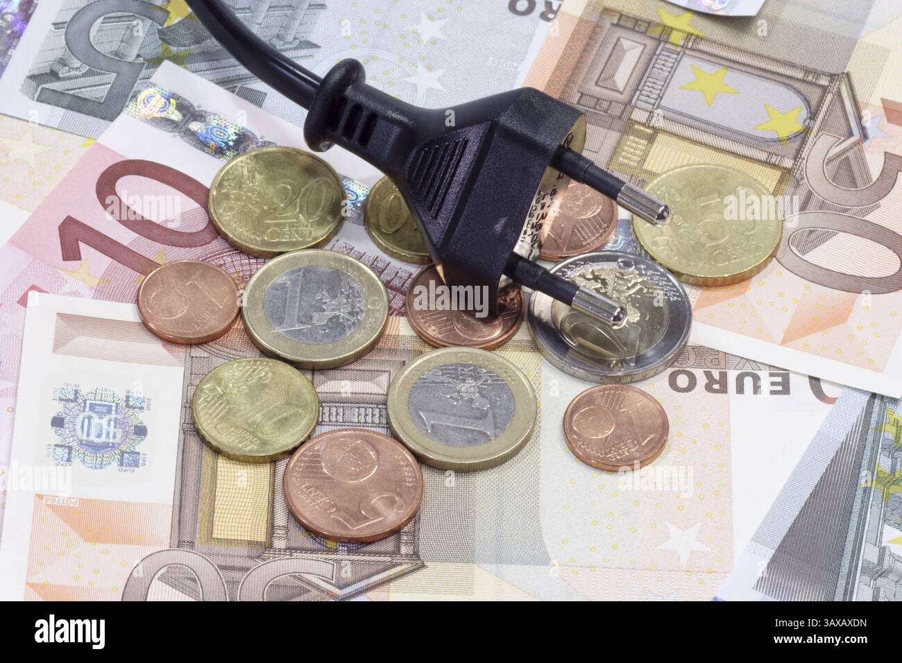 European currency in notes and coins with mains plug Stock Photo - Alamy