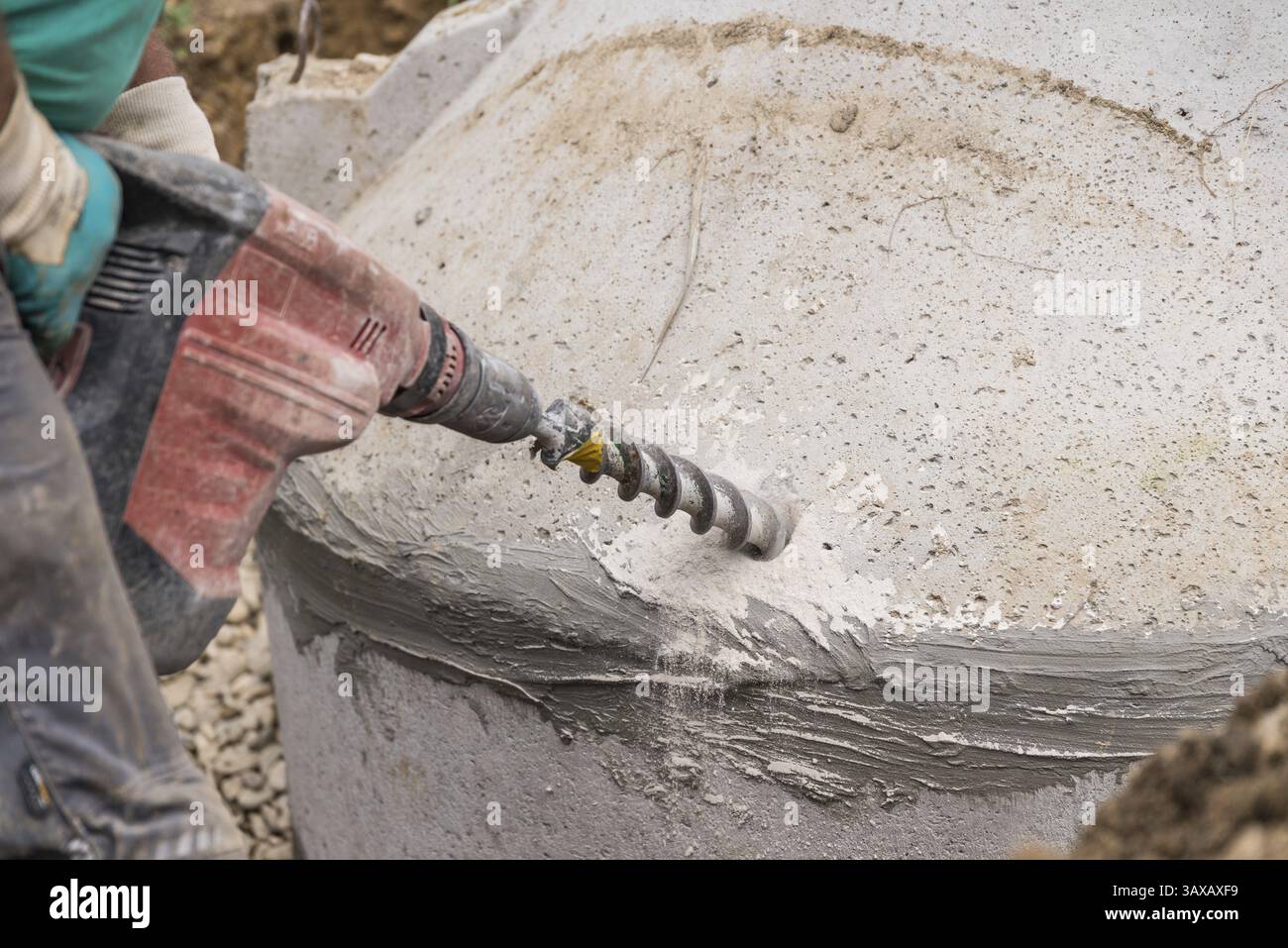 Construction worker on a building site with an impact drill ...