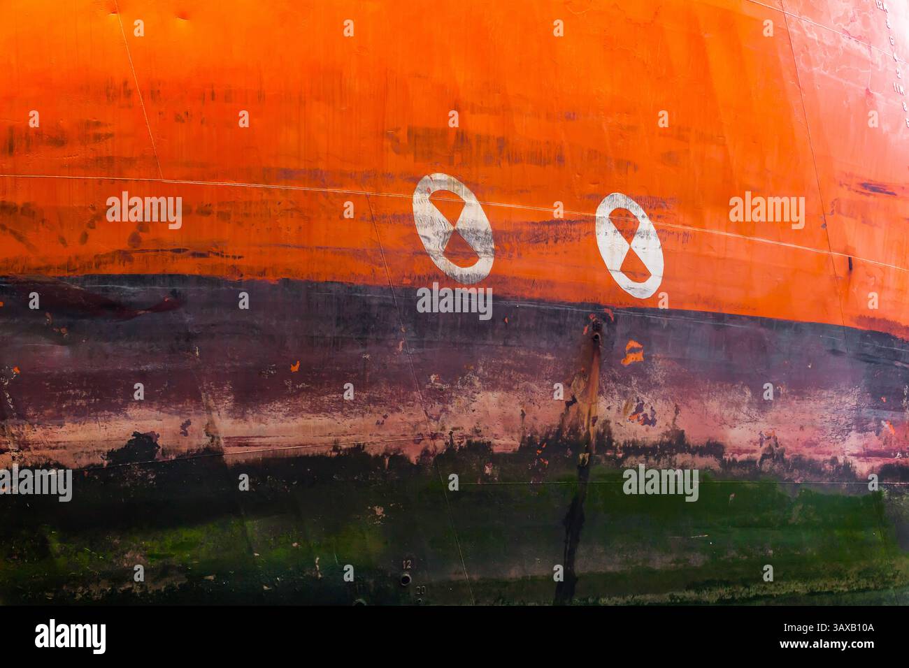 The hull of a large merchant ship with the immersion depth indicated on ...