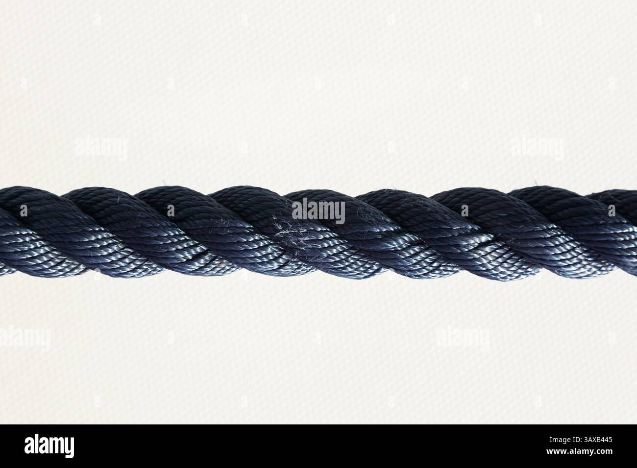 Black braided rope stretched evenly horizontally in the middle on a ...