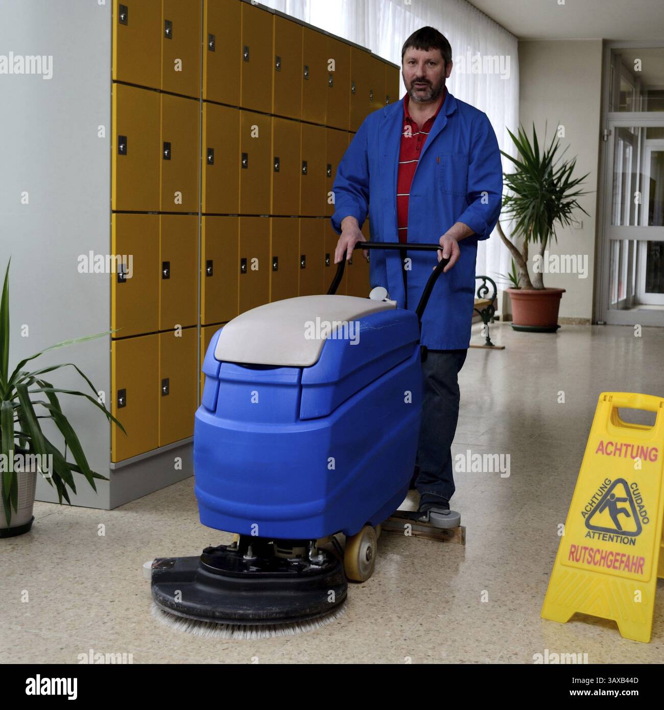 School caretaker with the cleaning machine Stock Photo - Alamy