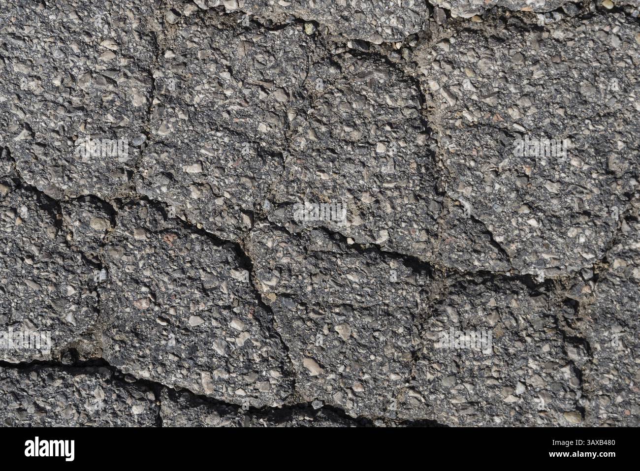 Cracks in the asphalt - background and irregular pattern Stock Photo ...
