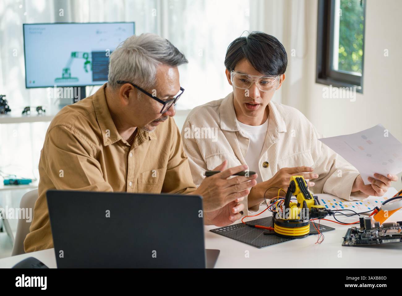 engineering robot technology with asian programmer innovation and research teamwork in coding ...