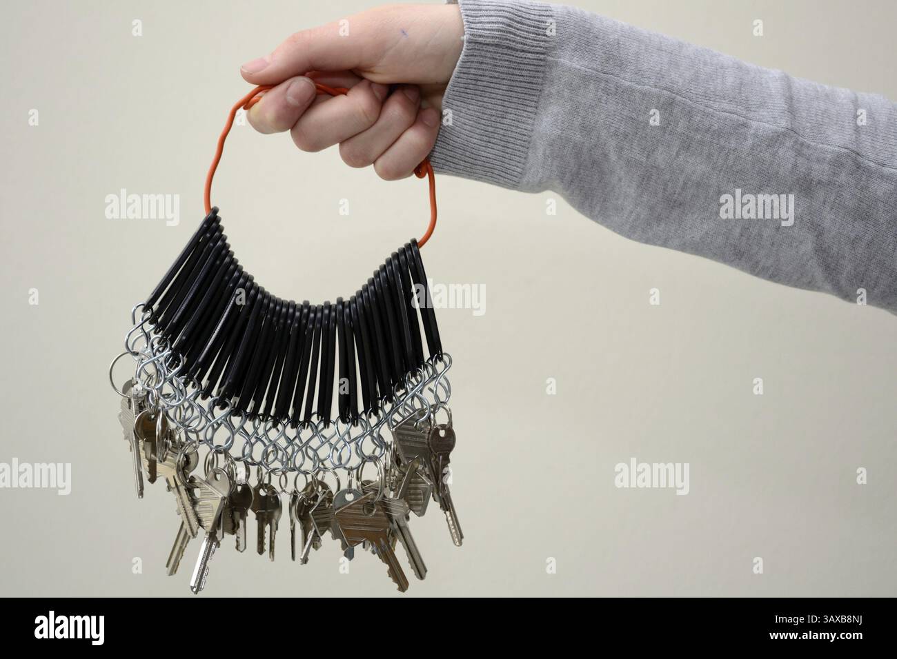 Large bunch of keys in the hand Stock Photo - Alamy