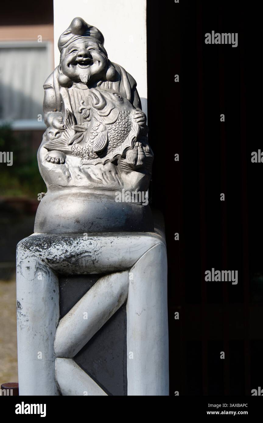 Photo shows a statue of Ebisu in the old quarters of Ozu City, Ehime ...