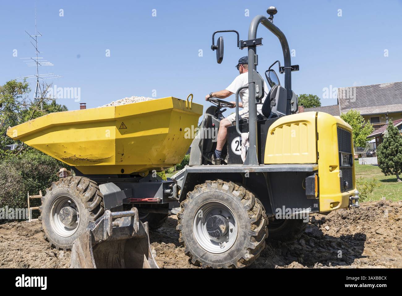 Construction worker with dumper on the construction site - construction ...