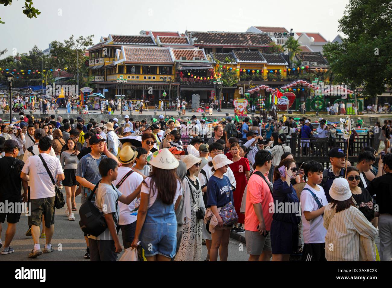 Tourism in Hoi An, Vietnam Tourists walk in Hoi Ans old town, in Hoi An ...