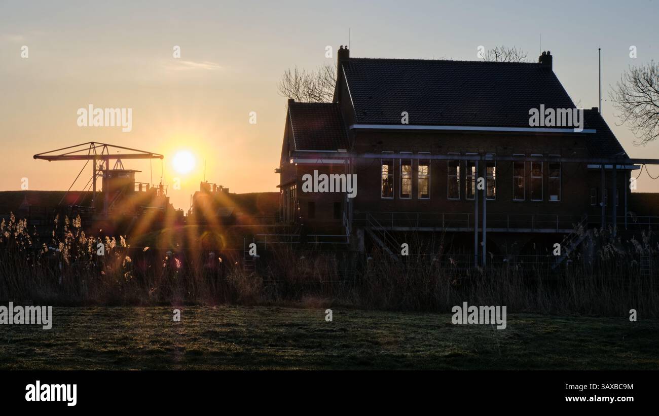 March 8, 2025 – Ezumazijl-Netherlands: Silhouettes of a sluice ...