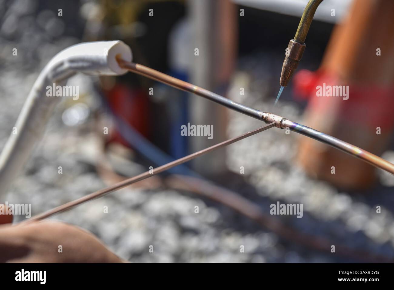 Tradesman working on site brazing copper pipe - Welding Stock Photo - Alamy