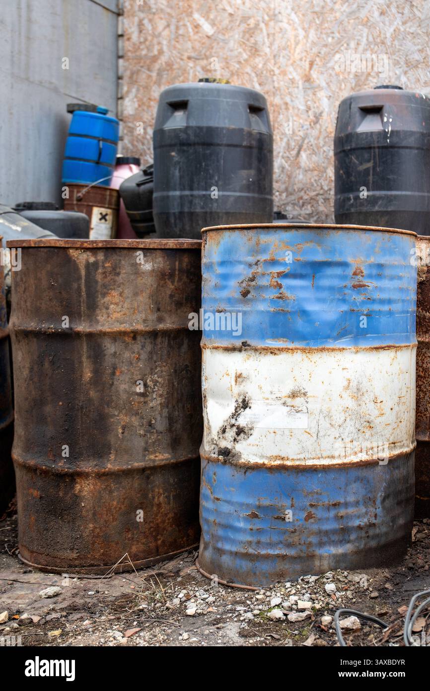 Rusty Barrels and Containers in Industrial Storage Area Stock Photo - Alamy