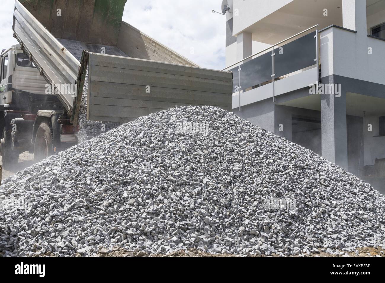Lorry unloads gravel on construction site - crushed gravel ...