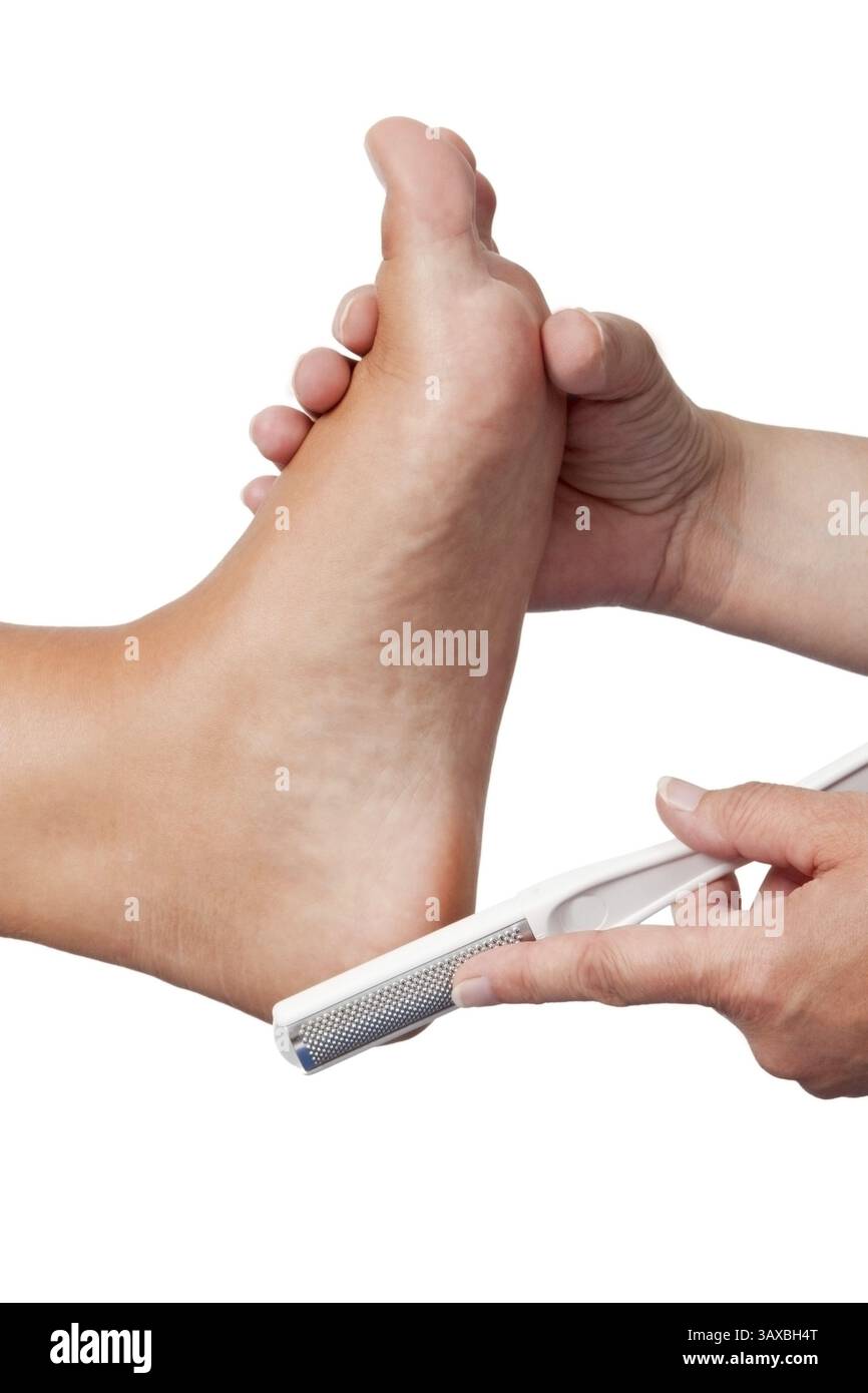 Callus removal on a female foot - cut-out Stock Photo - Alamy