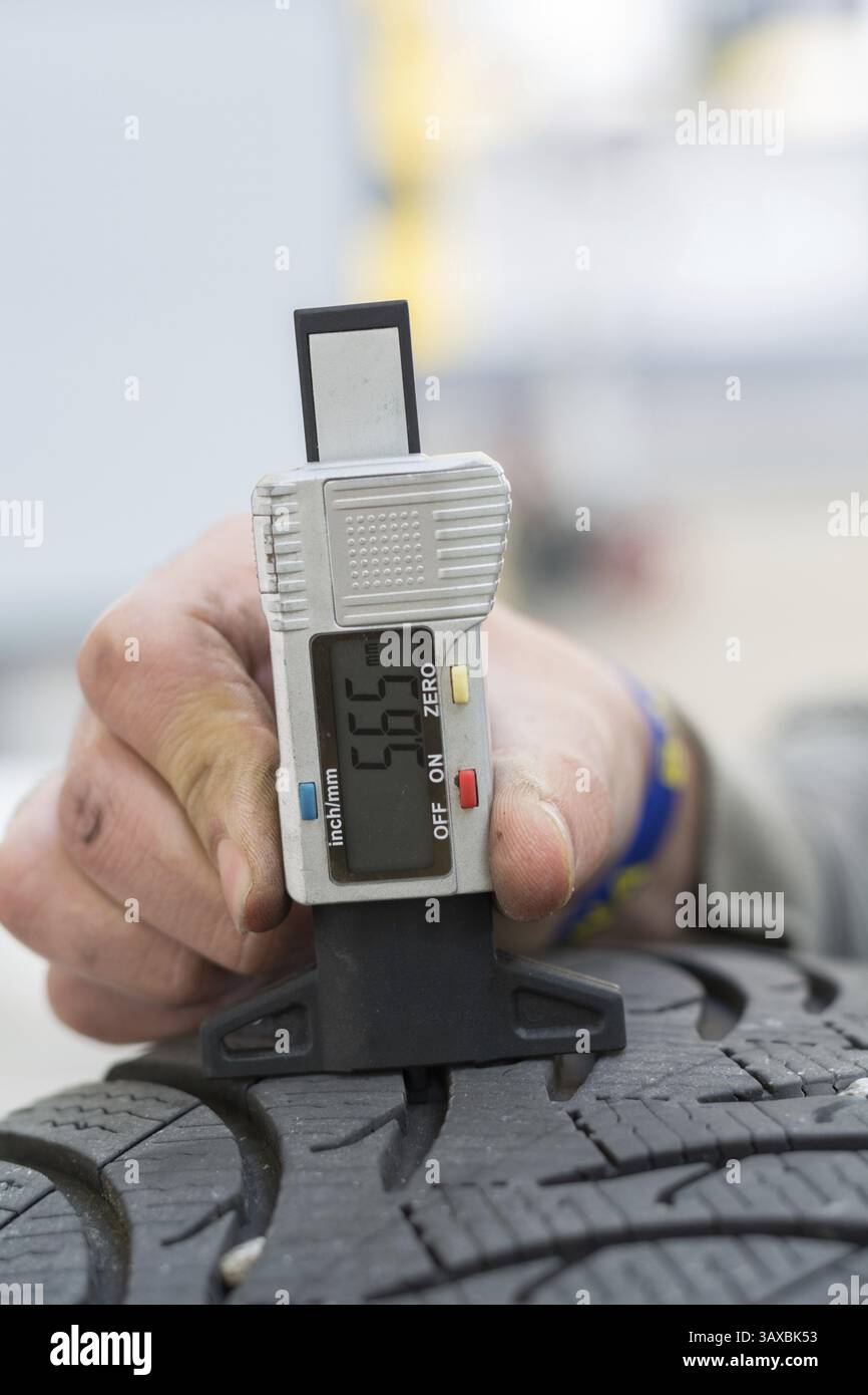 Person measures tyre tread depth with tread depth gauge Stock Photo - Alamy
