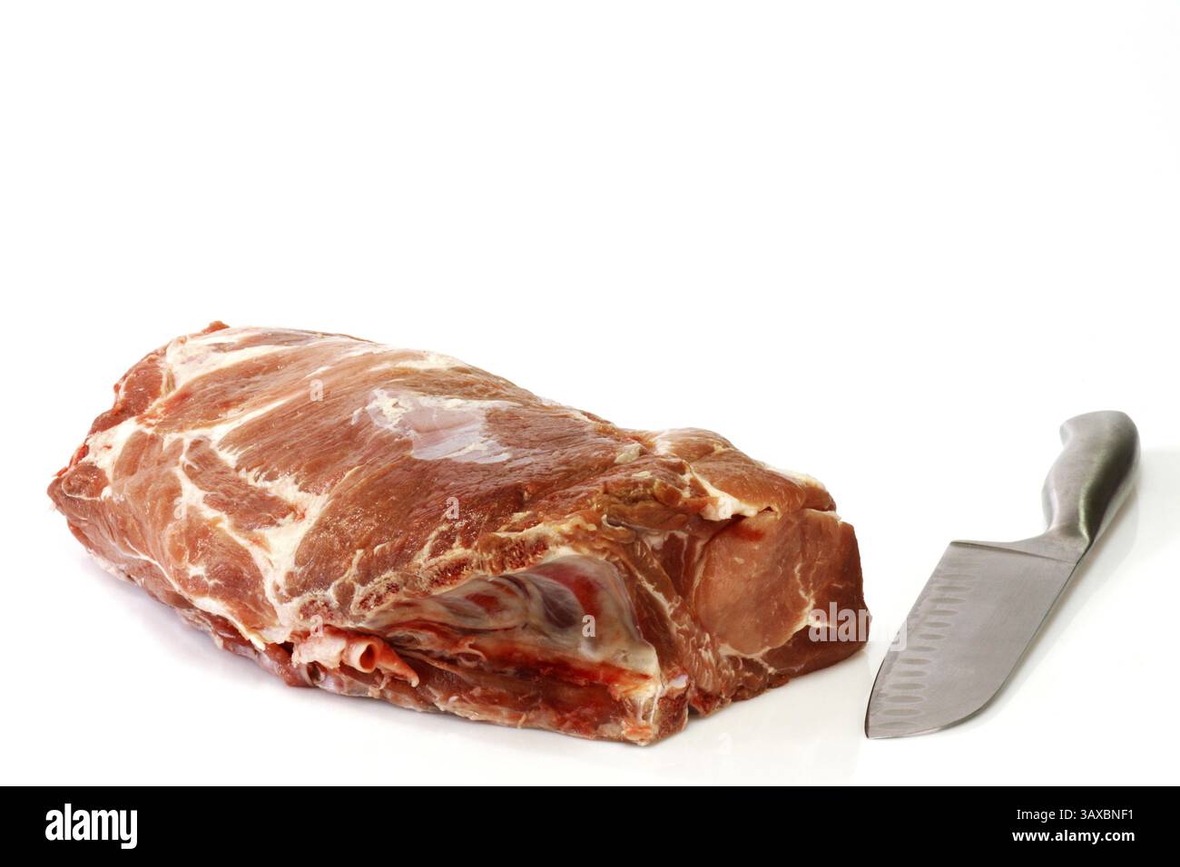Raw pork loin and meat knife - cropped on a white background Stock ...
