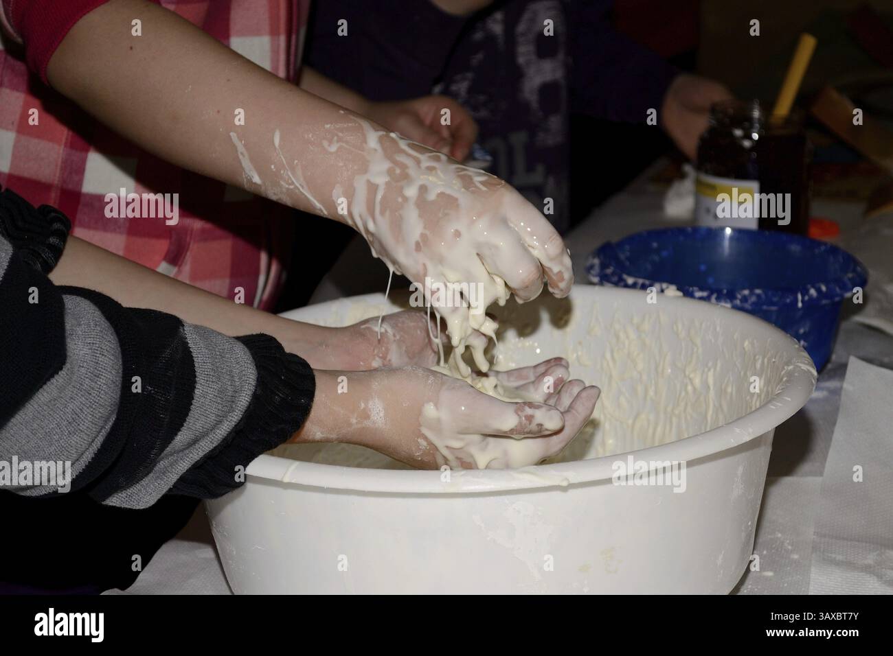 Children's hands mix modelling clay Stock Photo - Alamy