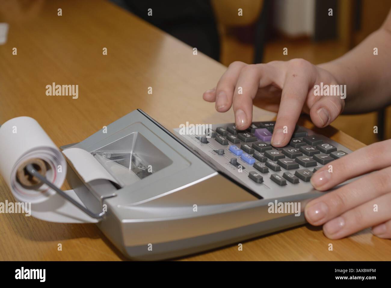 Office worker calculating with a printing calculator - close-up Stock ...
