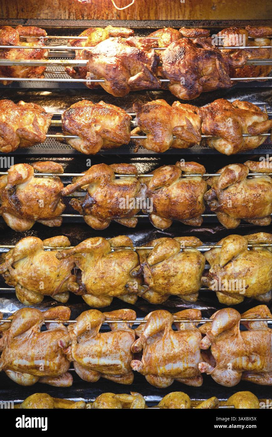 Chicken is grilled on a spit - chicken, grilled meat Stock Photo - Alamy