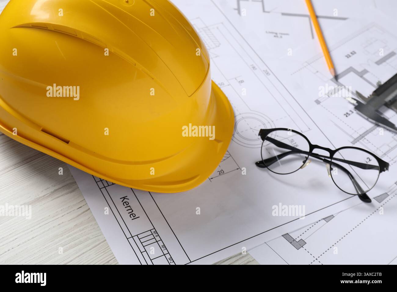 Different engineering drawings, hard hat, pencil, vernier caliper and ...