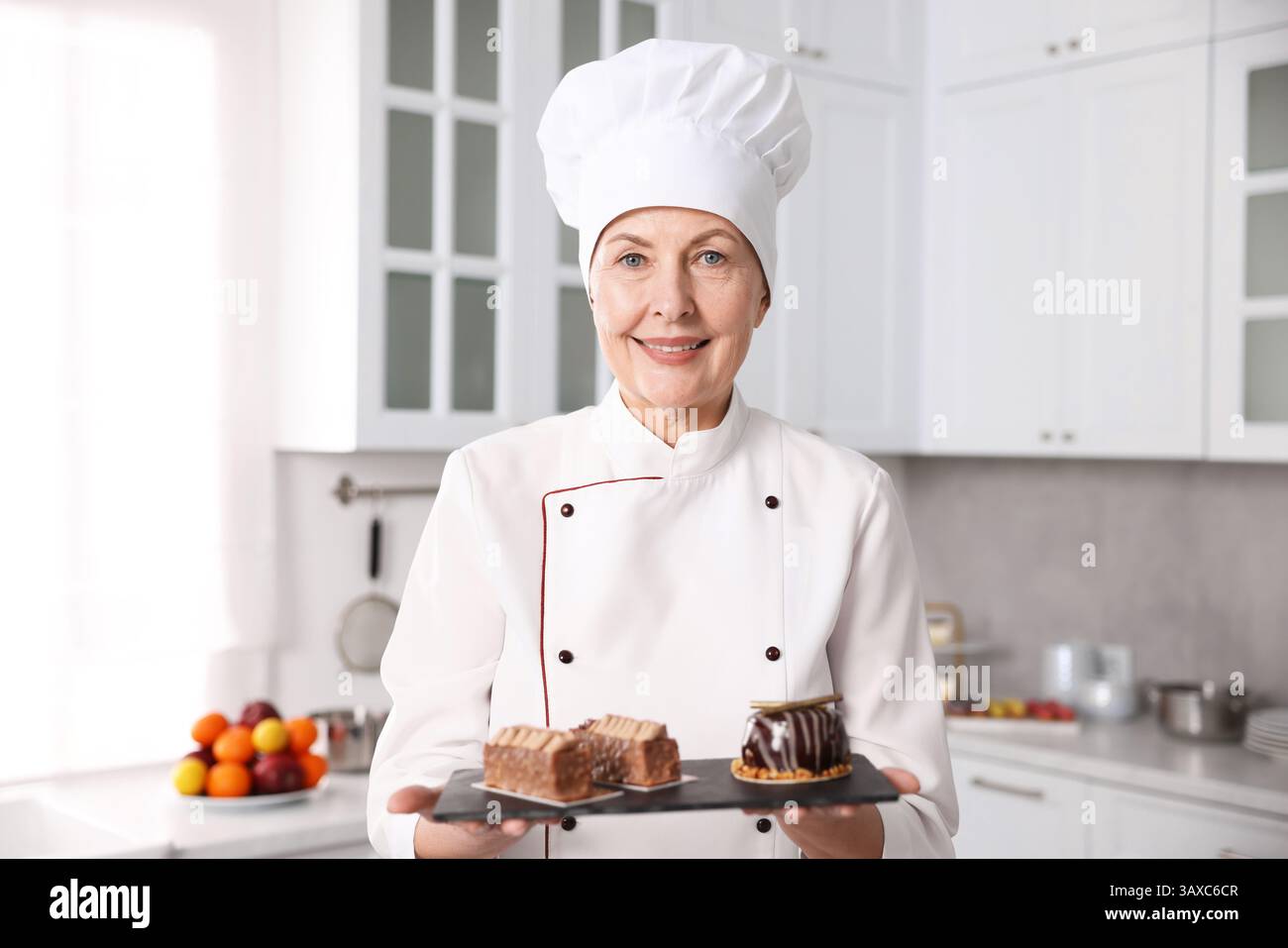 Professional pastry chef with desserts in kitchen Stock Photo - Alamy