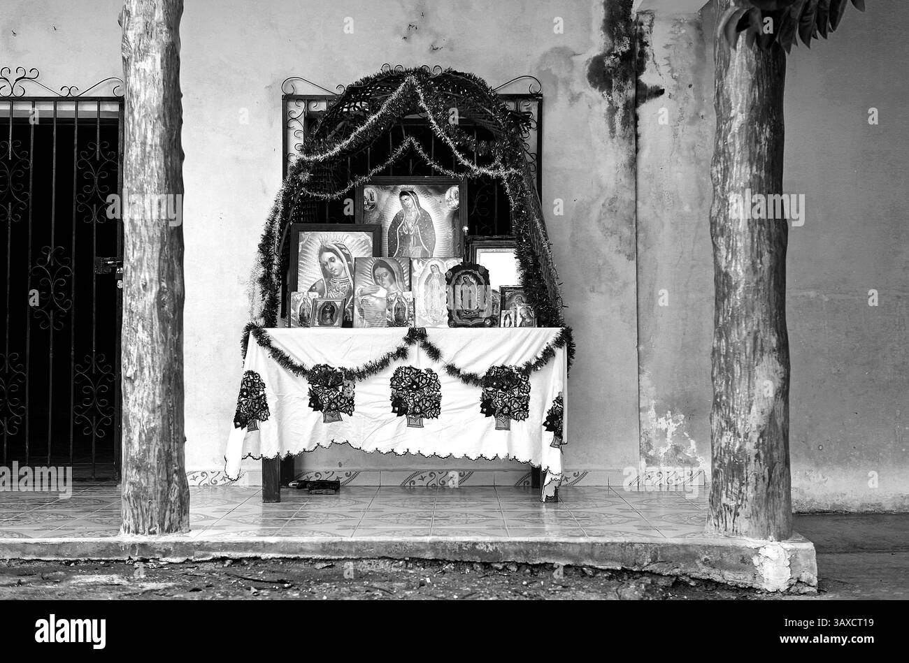 Images of Our Lady of Guadalupe at a small makeshift altar on the porch ...