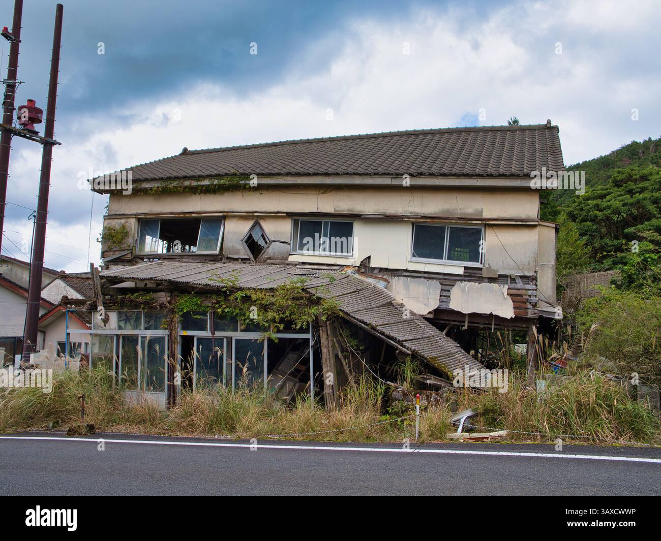 Earthquake-damaged abandoned house with collapsed roof in central ...