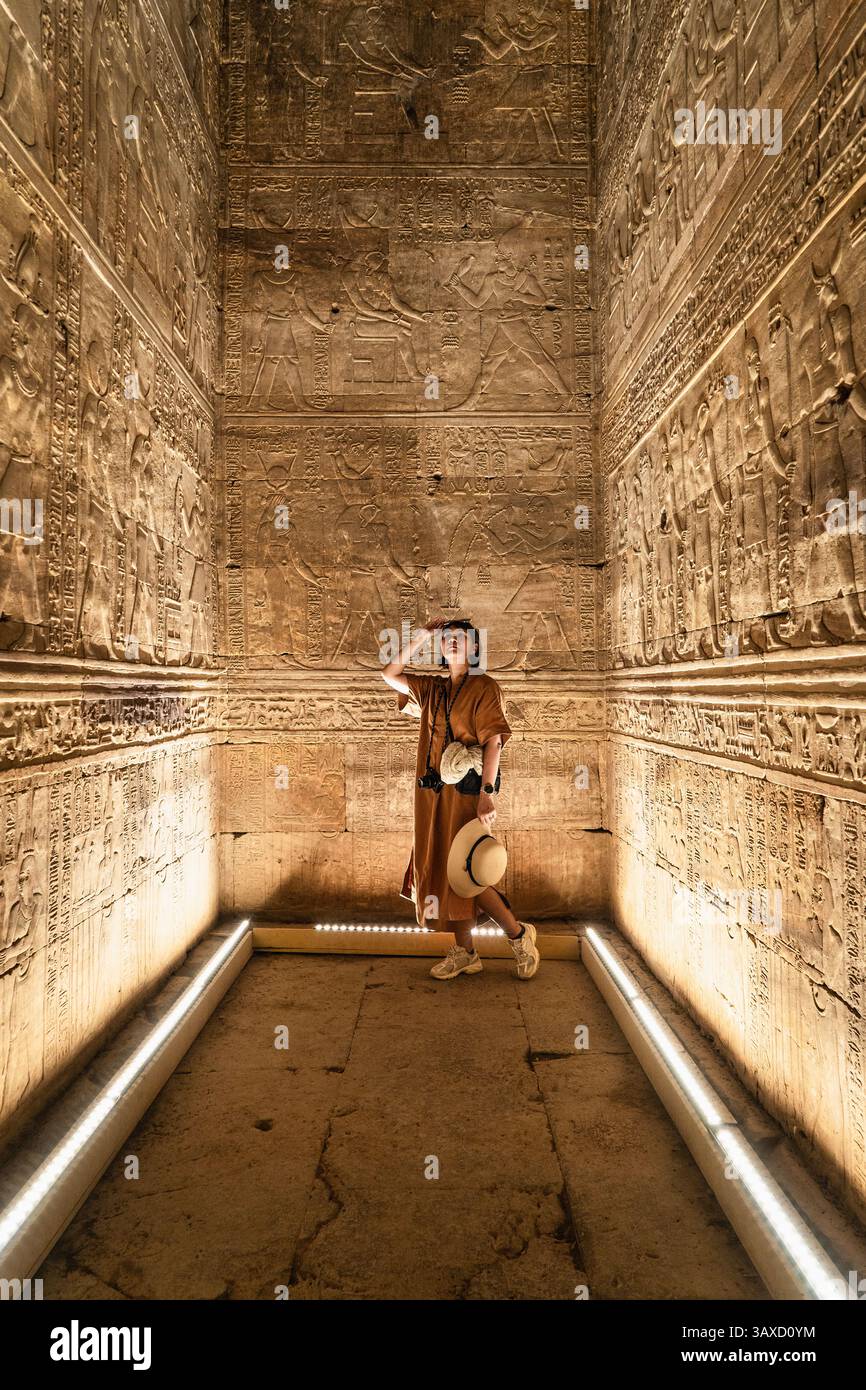 woman exploring the temple of Horus close to the river Nile / Egypt ...
