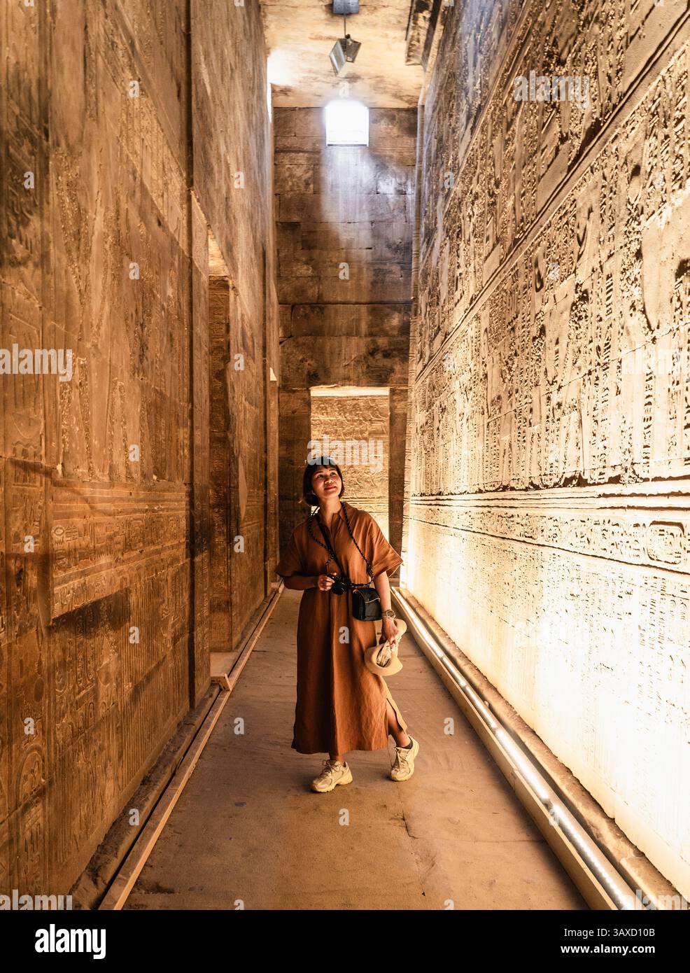 woman exploring the temple of Horus close to the river Nile / Egypt ...
