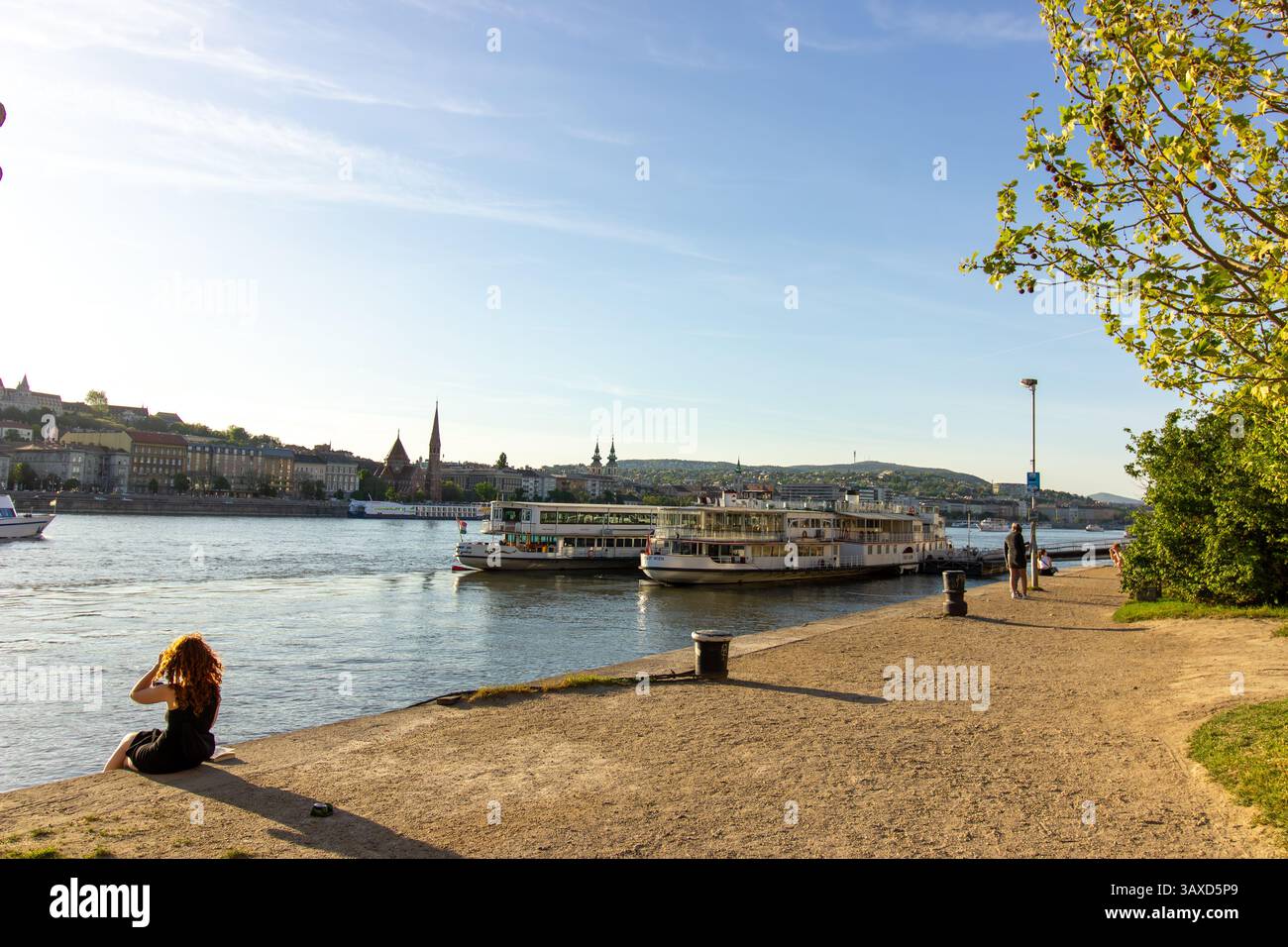 Scenic riverside view of Danube in Budapest with docked cruise boats ...