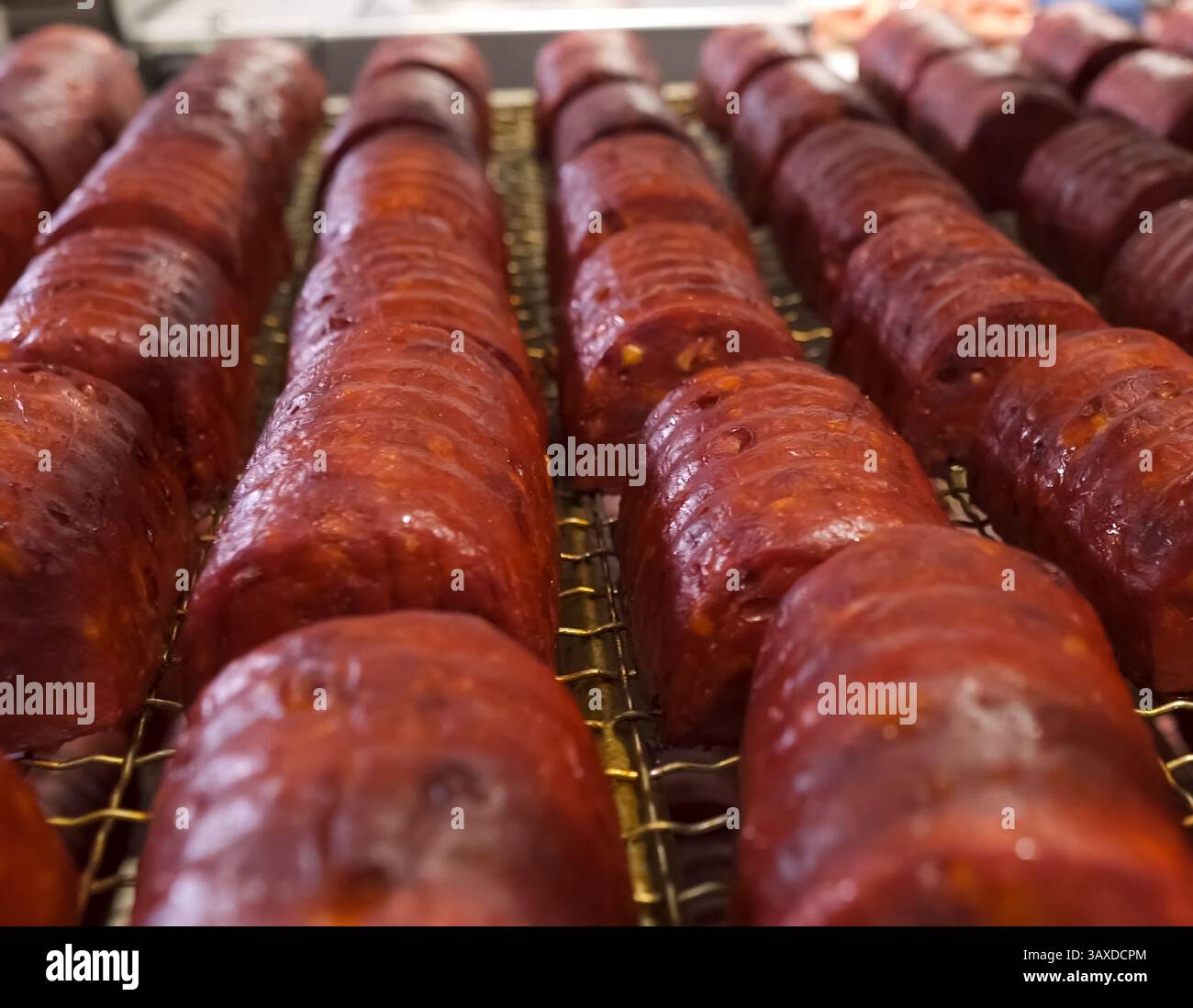 The sausage hangs on a rack in the sausage factory. production of ...