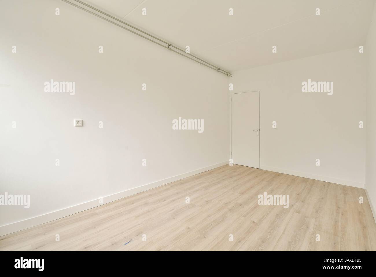 An unadorned and minimalist interior of an empty room showcasing light ...