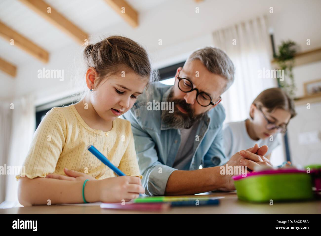 Father helping his daughters with homework Stock Photo - Alamy